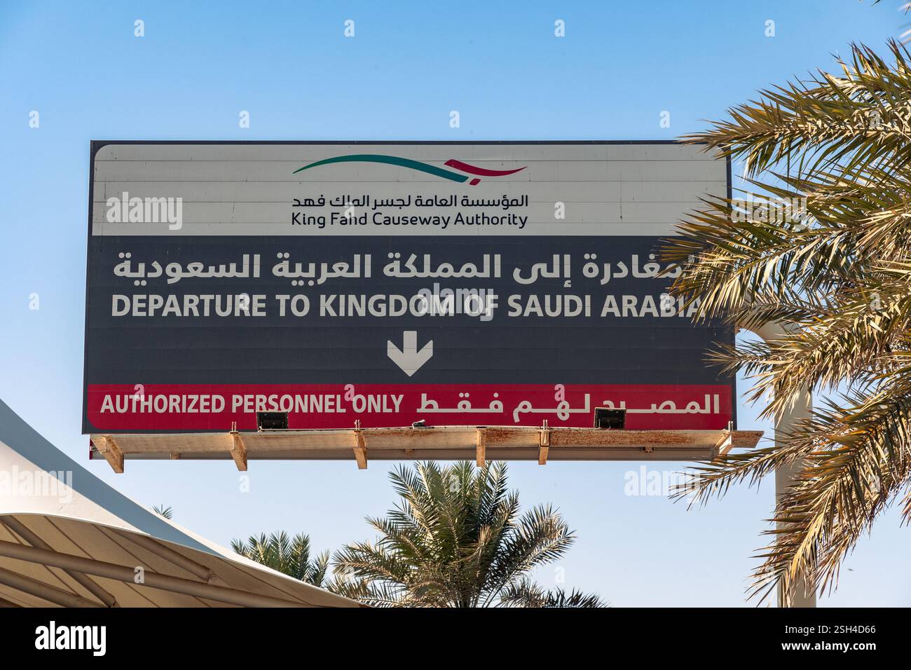 Manama, Bahrain - January 5, 2025: A road sign stands prominently on ...