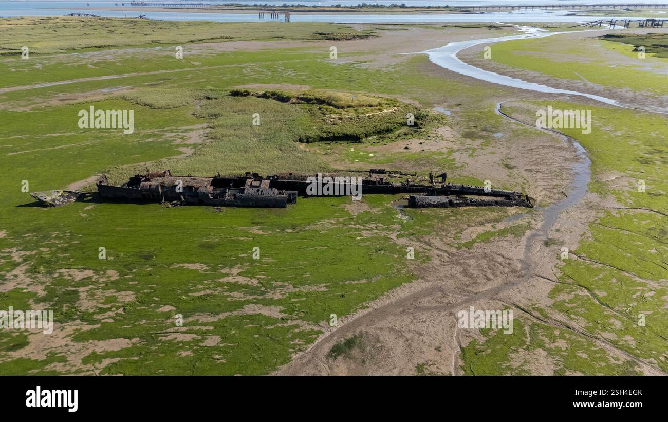 Aerial view of a German UBoat shipwreck on a grassy tidal flat with a ...