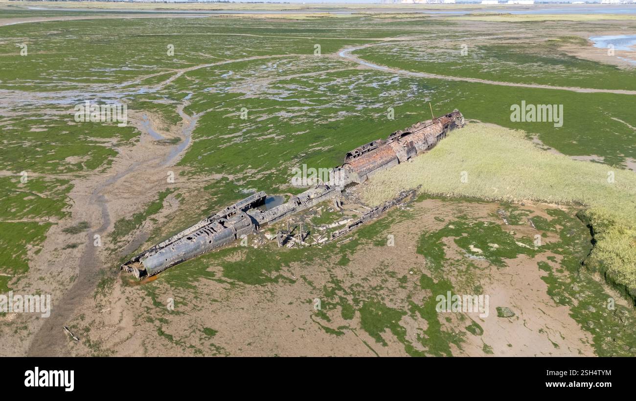 Aerial view of a rusted German UBoat shipwreck partially buried in a ...