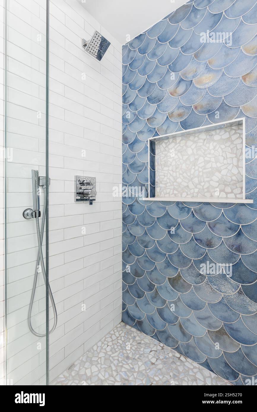 A shower detail with blue scale tiles and white subway tile walls ...