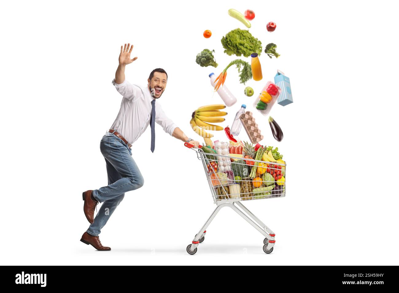 Cheerful man running with falling groceries in a shopping cart and ...