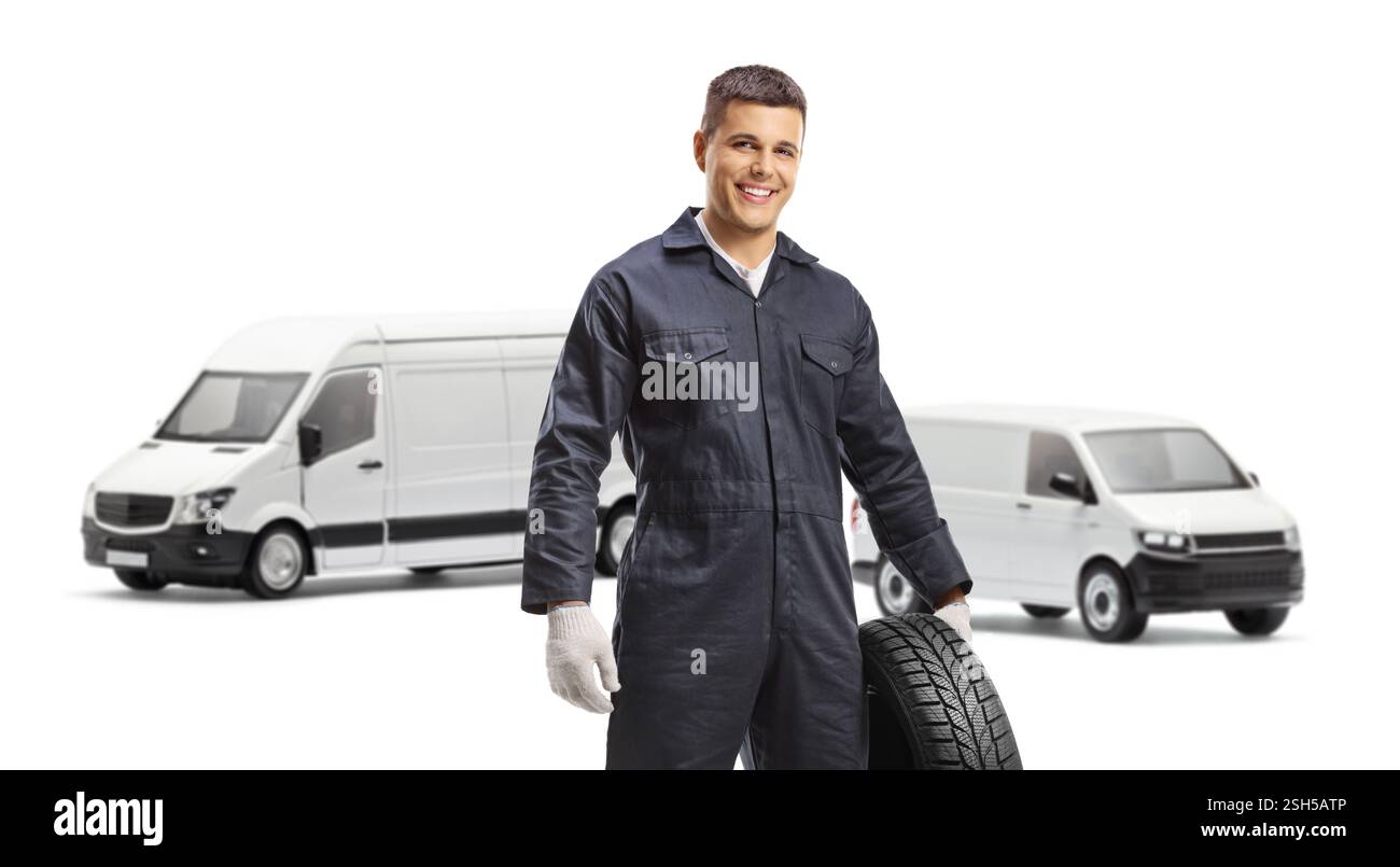 Auto mechanic in a uniform holding van tires isolated on white ...