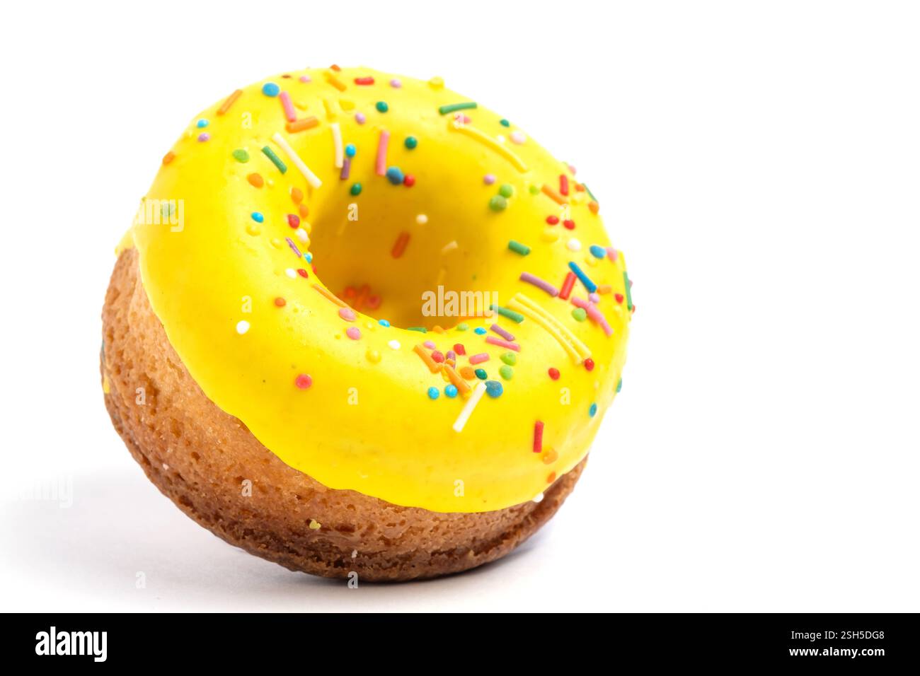 Donut with yellow icing isolated on white background. Closeup Stock ...