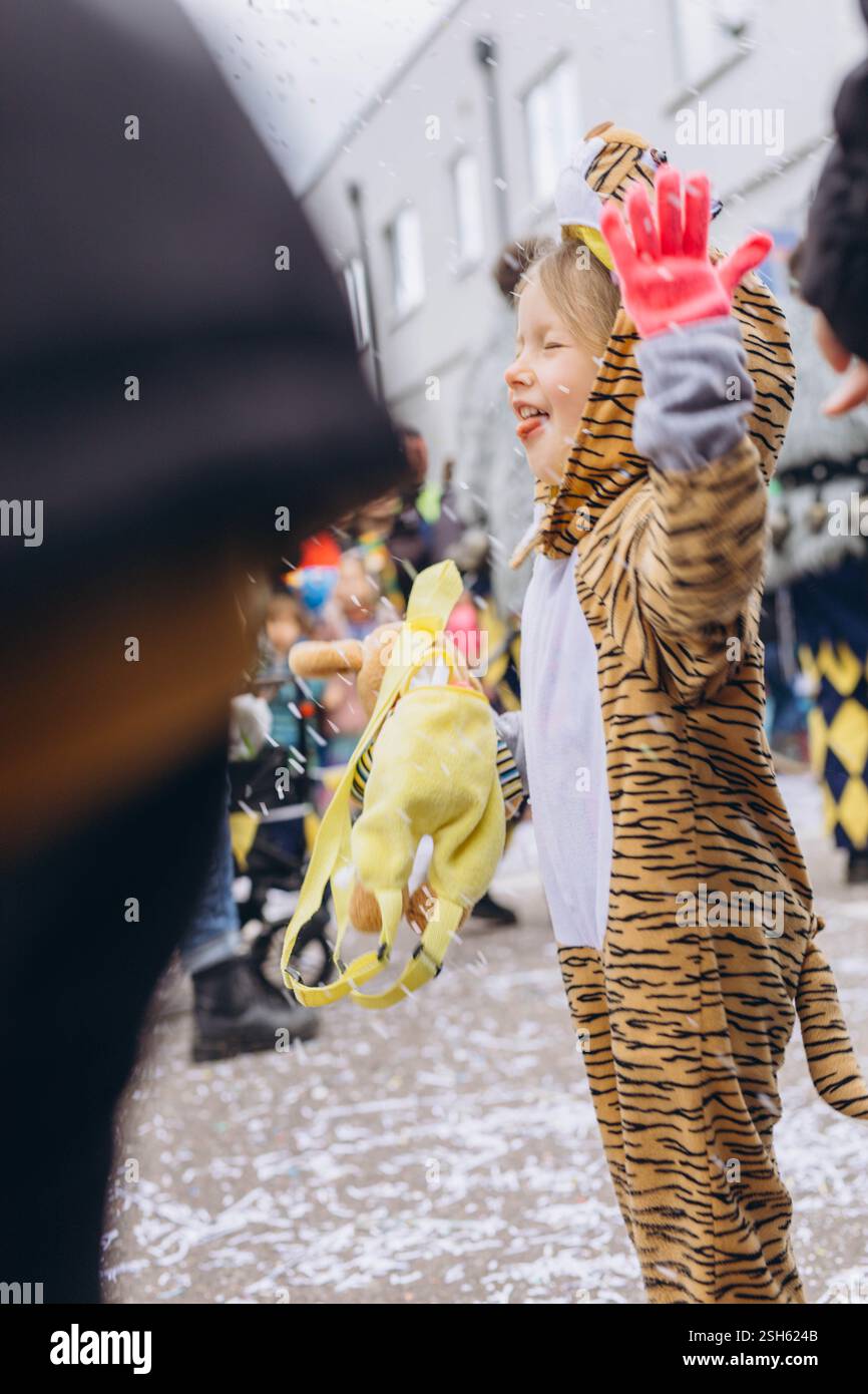 5-year-old girl in a tiger costume at a carnival in Germany, full of ...