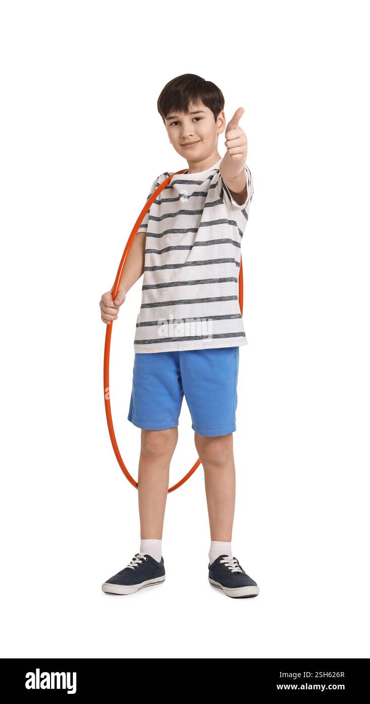 Boy with hula hoop showing thumbs up on white background Stock Photo ...