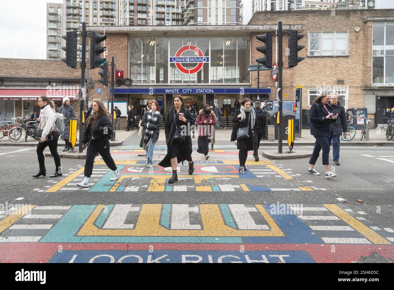 Pedestrians cross the colorful pedestrian crossing at White City ...