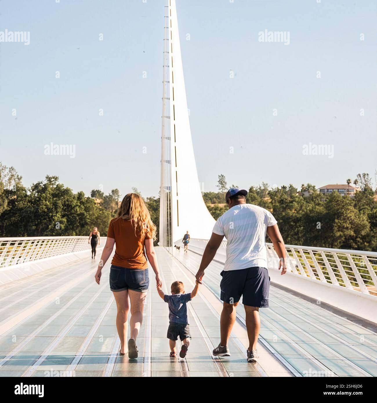 Family on Sundial Bridge: A family walks hand-in-hand across the ...