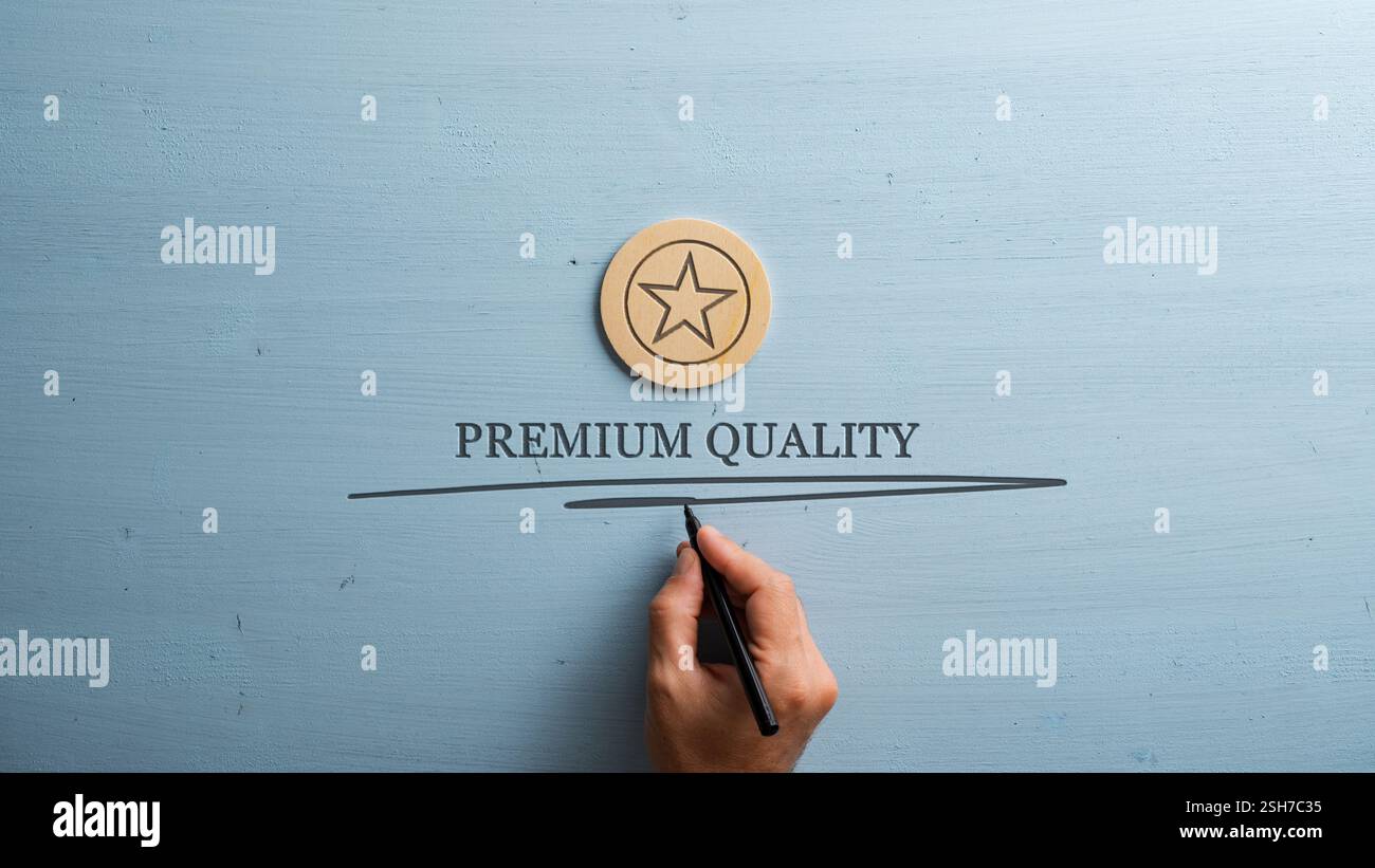 A star engraved in wooden token with a male hand writing Premium ...