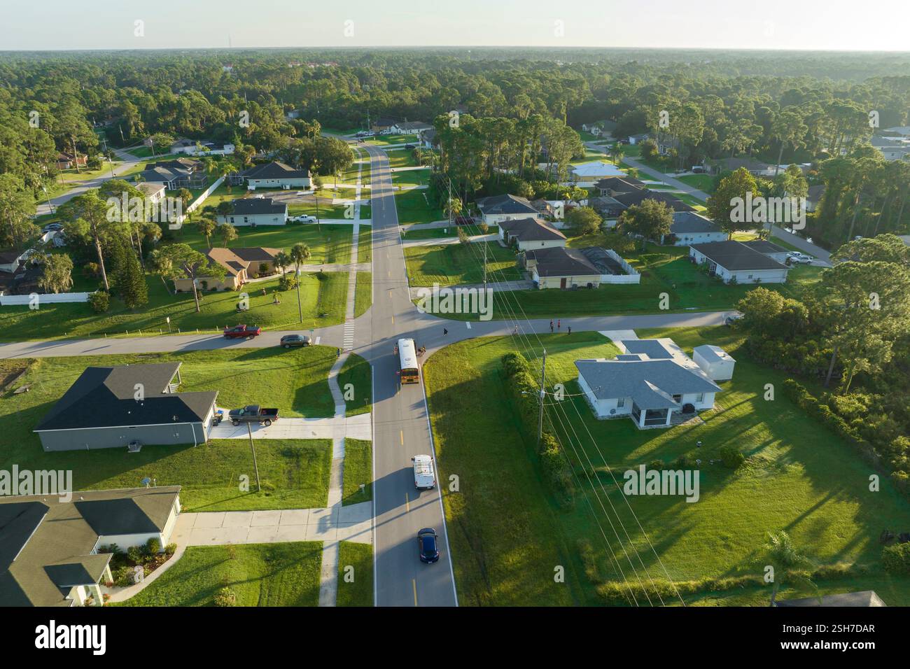 Aerial view of american yellow school bus picking up children at ...