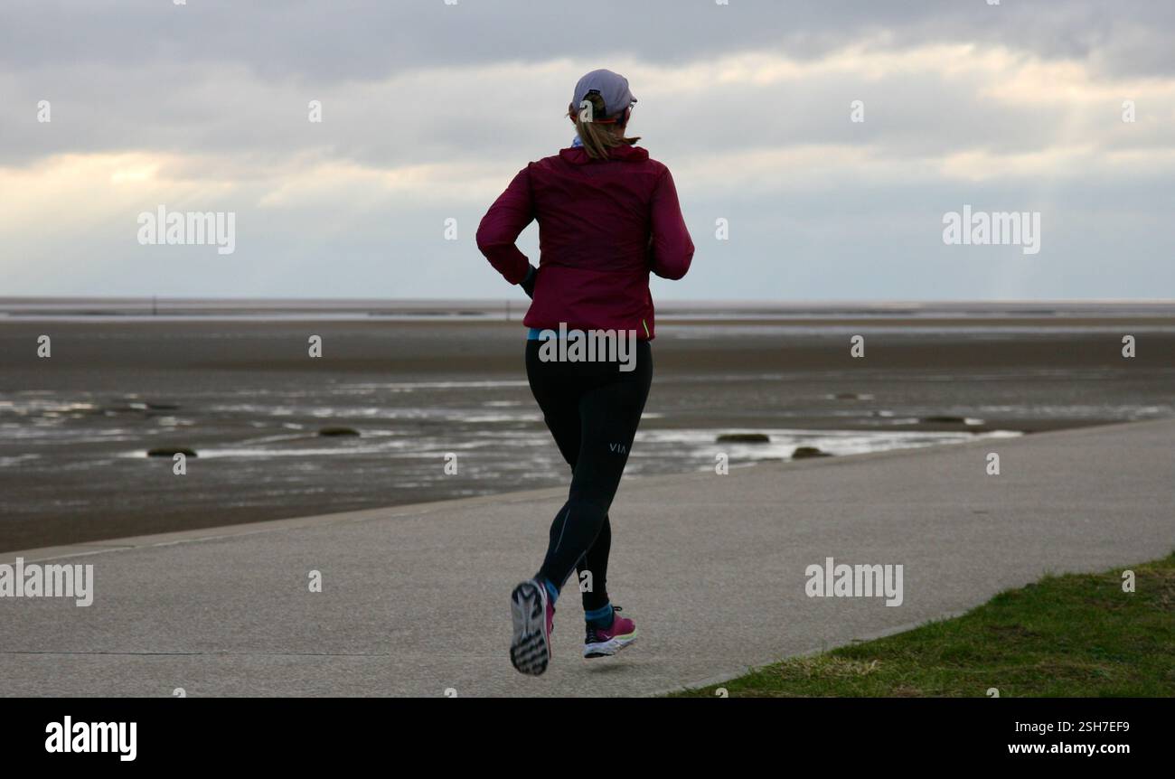 A lady runner on the seafront Stock Photo - Alamy