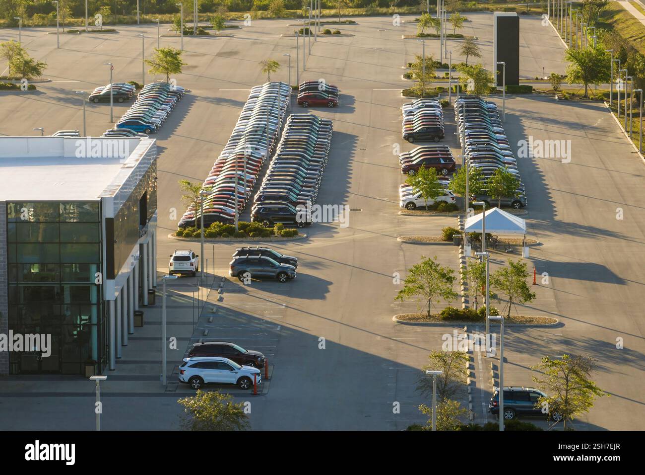 Aerial view of dealership parking lot with many brand new cars for sale ...