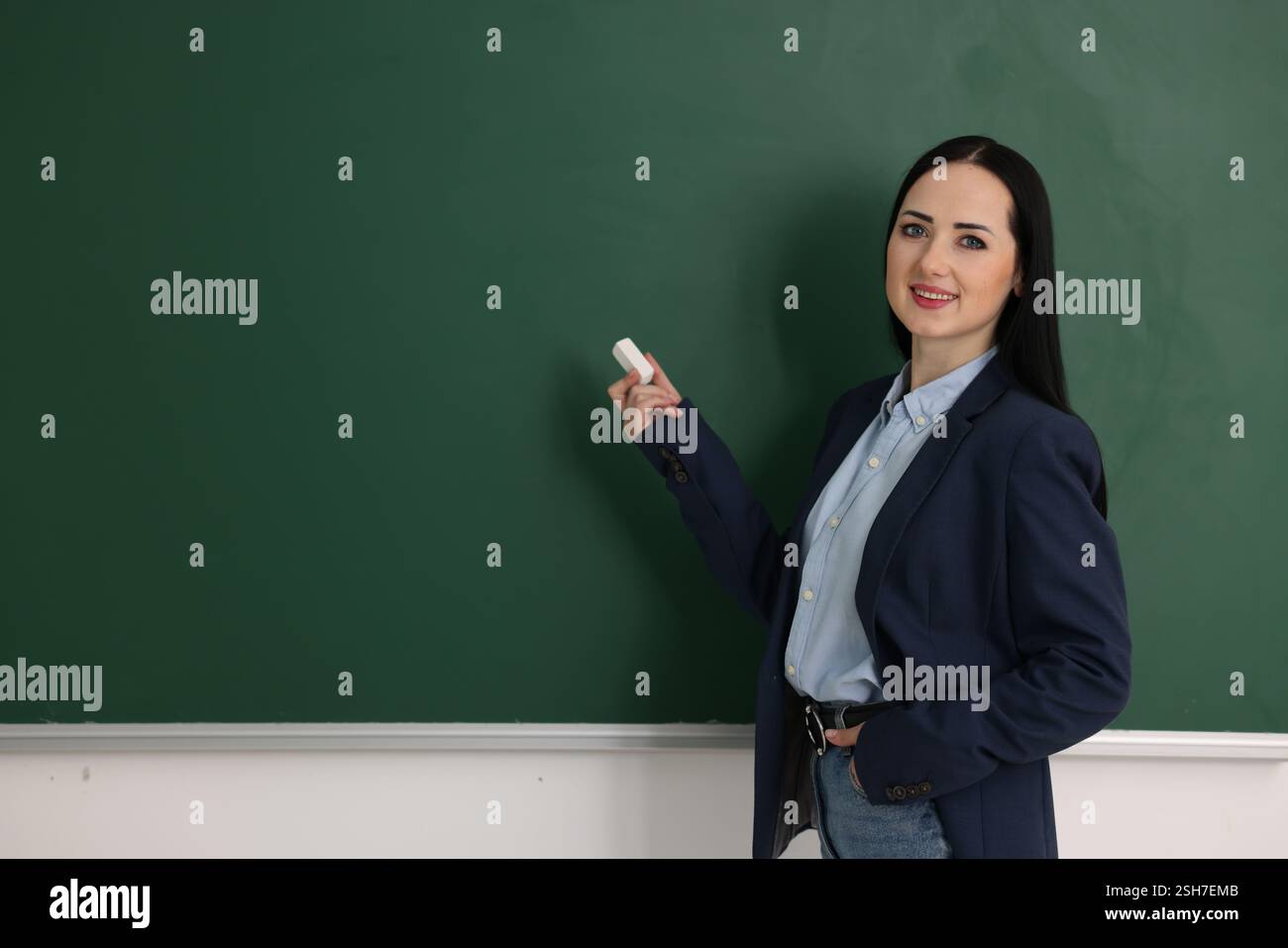 English teacher near chalkboard in classroom. Space for text Stock ...