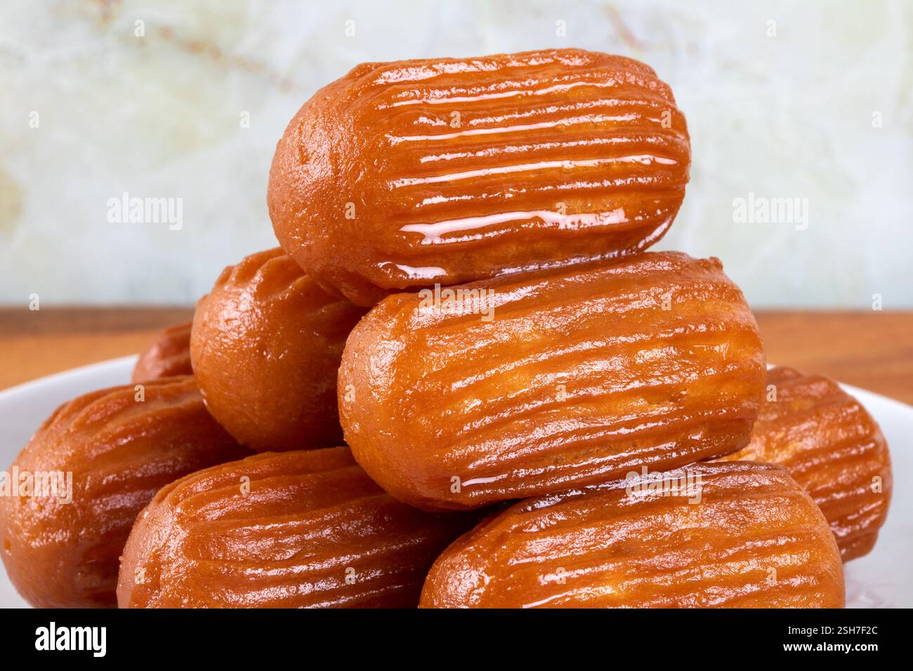 Traditional Turkish dessert tulumba on a plate. Tulumba dessert, fried ...