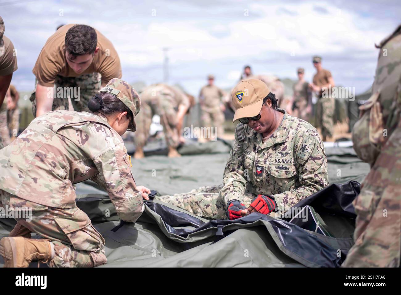 U.S. Navy Sailors and Army Soldiers set up tents at Naval Station ...
