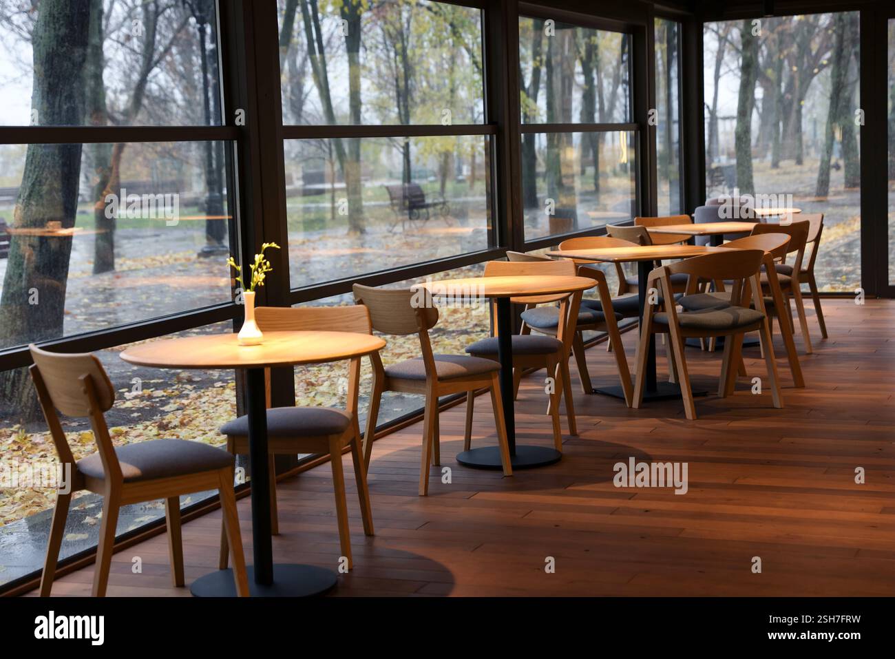 Stylish cafe with large windows and comfortable furniture. Interior ...