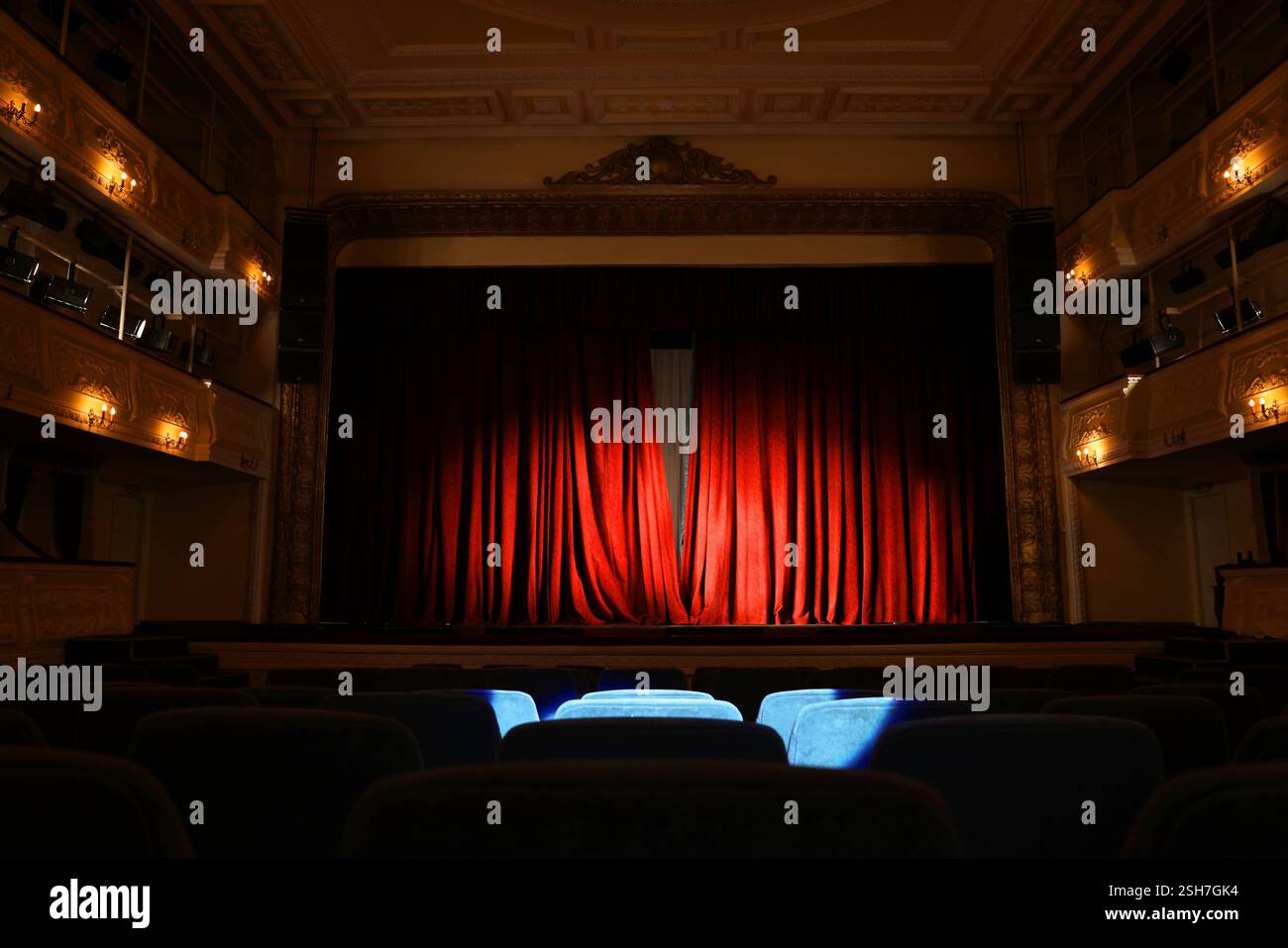 Elegant closed red curtains illuminated by spotlight in theatre Stock ...