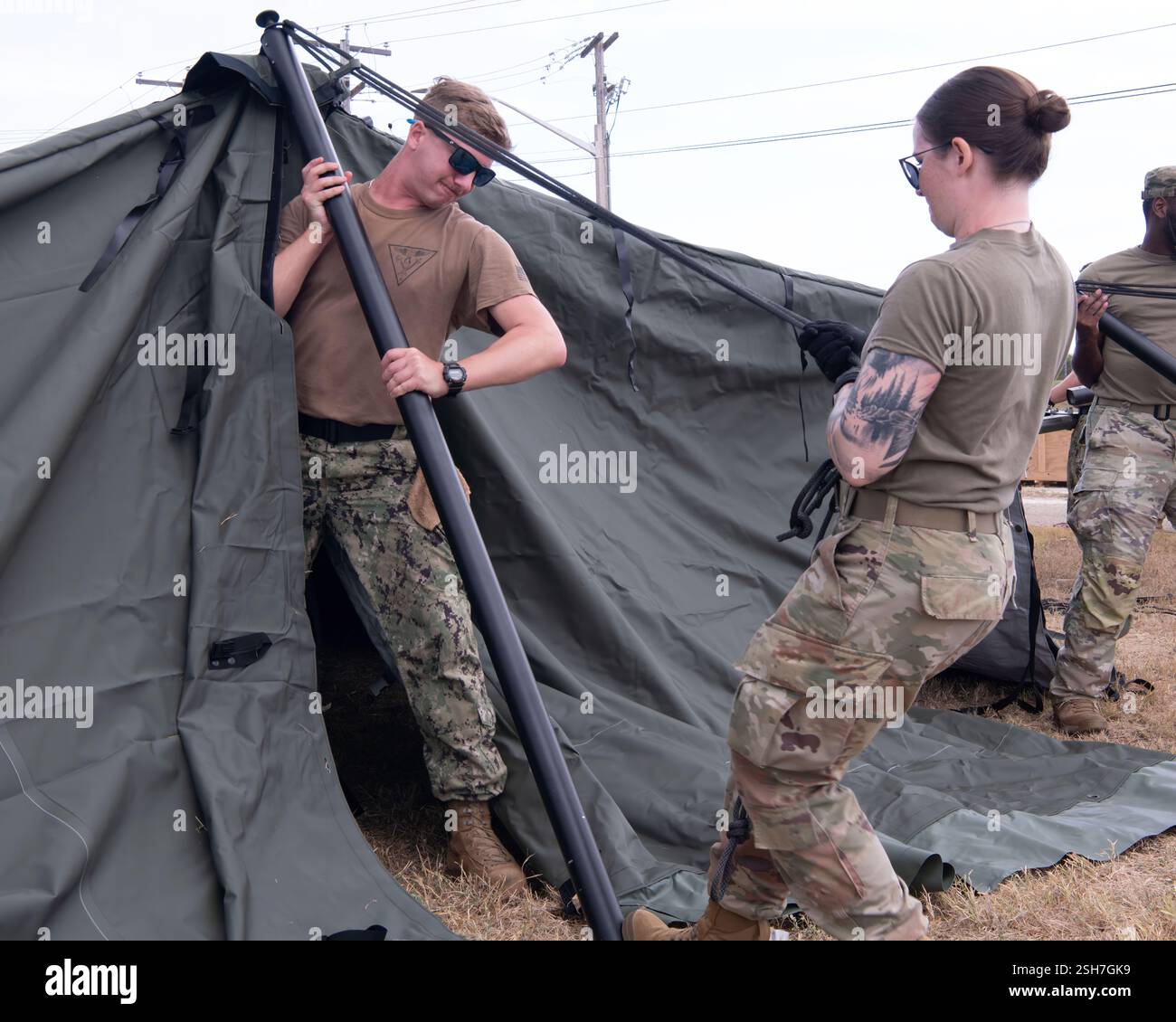 U.S. Navy Sailors and Army Soldiers set up tents at Naval Station ...