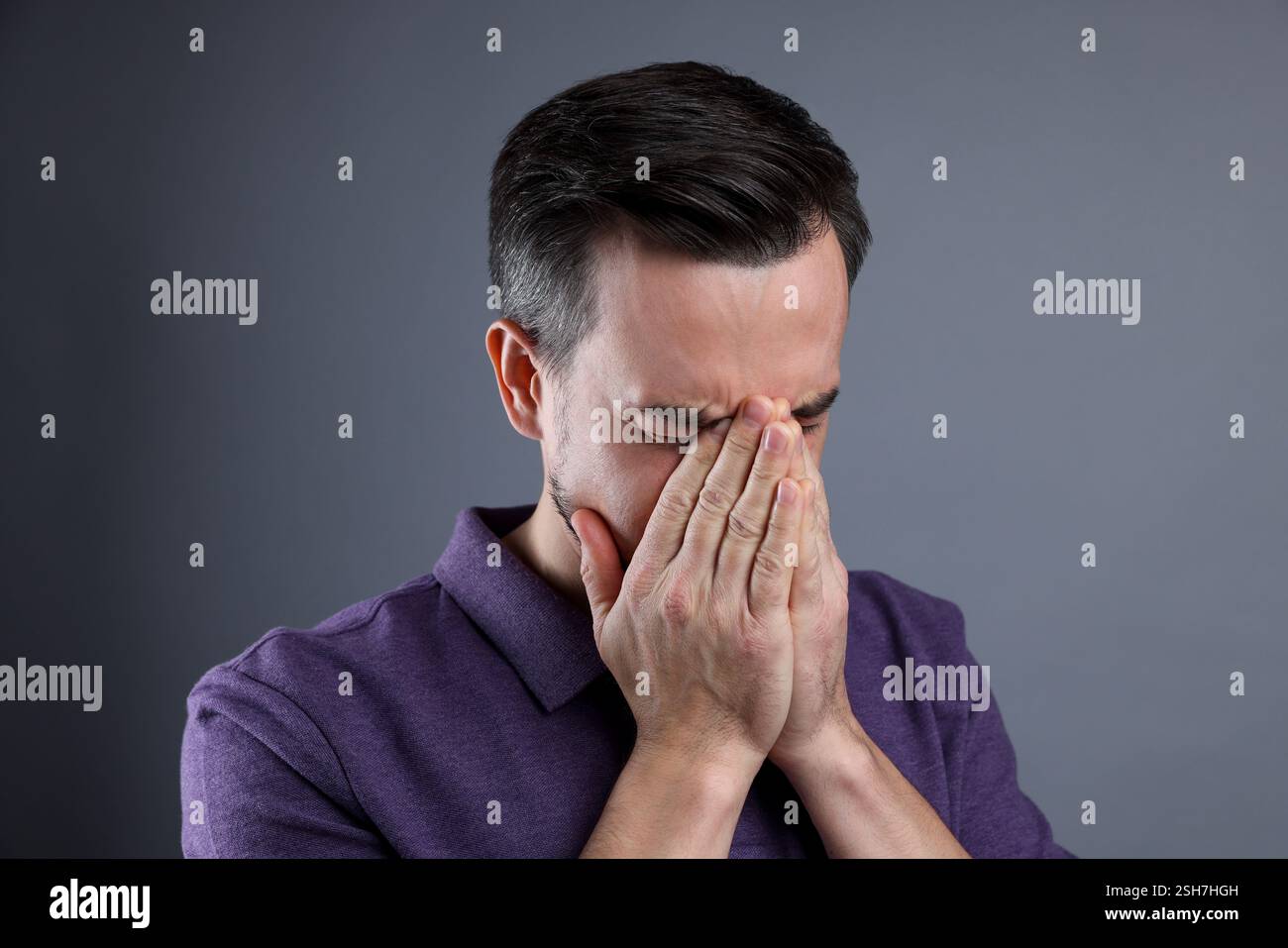 Portrait of sad man crying on grey background Stock Photo - Alamy