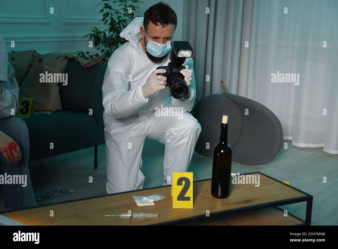 Forensic expert with camera working and victim at crime scene indoors ...