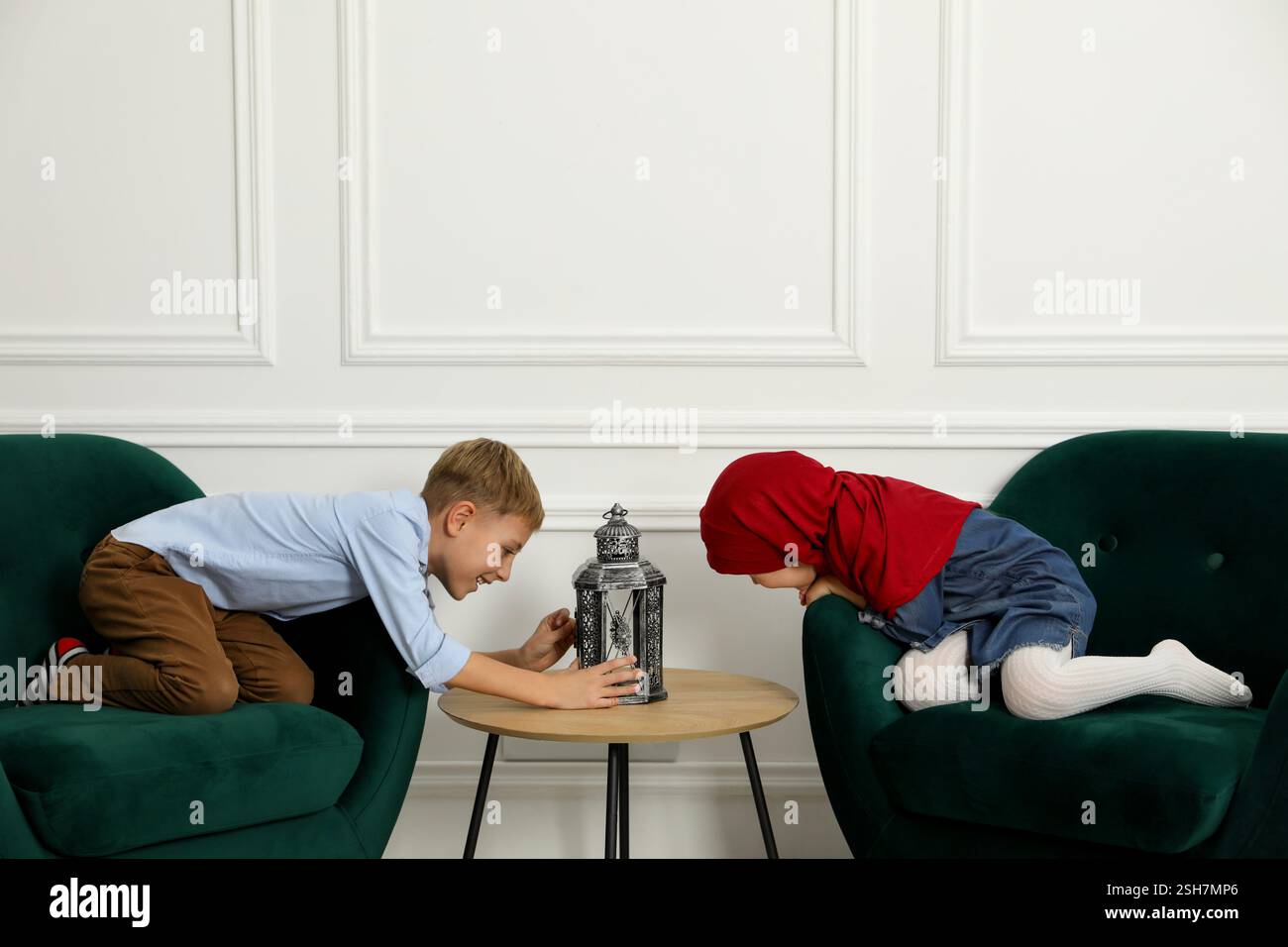 Muslim sister and brother spending time together at home Stock Photo ...