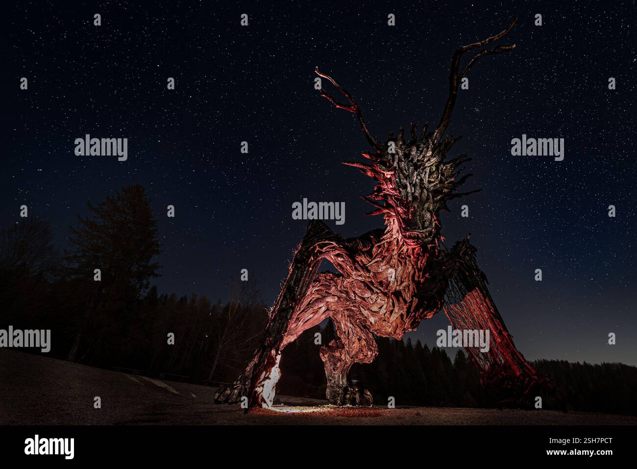 Vaia Dragon wooden sculpture on Lavarone captured at night Stock Photo ...