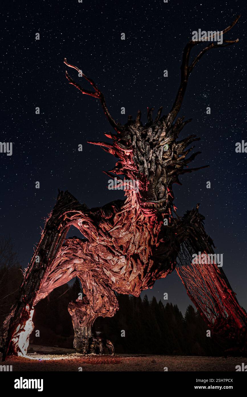 Vaia Dragon wooden sculpture on Lavarone captured at night Stock Photo ...