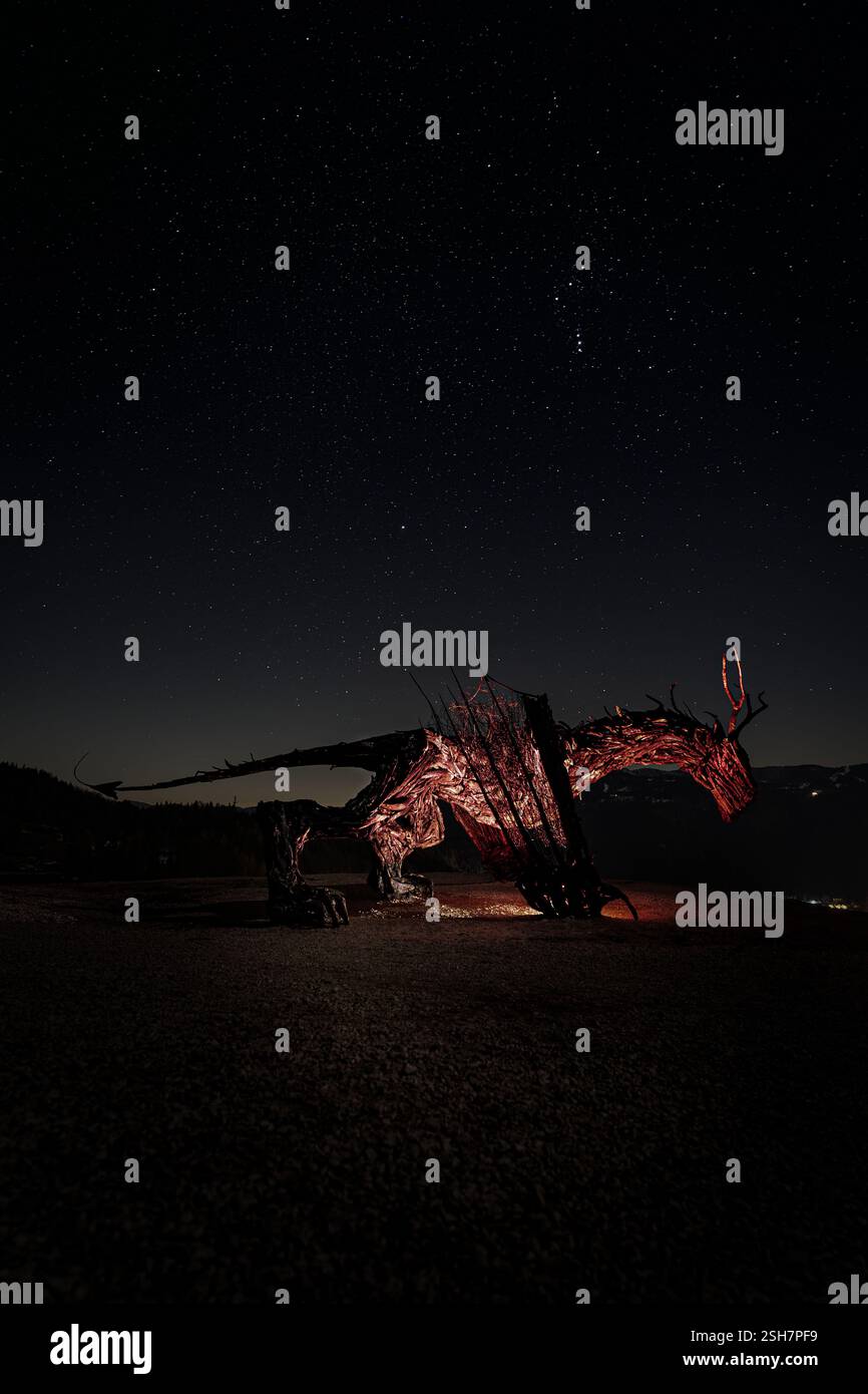 Vaia Dragon wooden sculpture on Lavarone captured at night Stock Photo ...