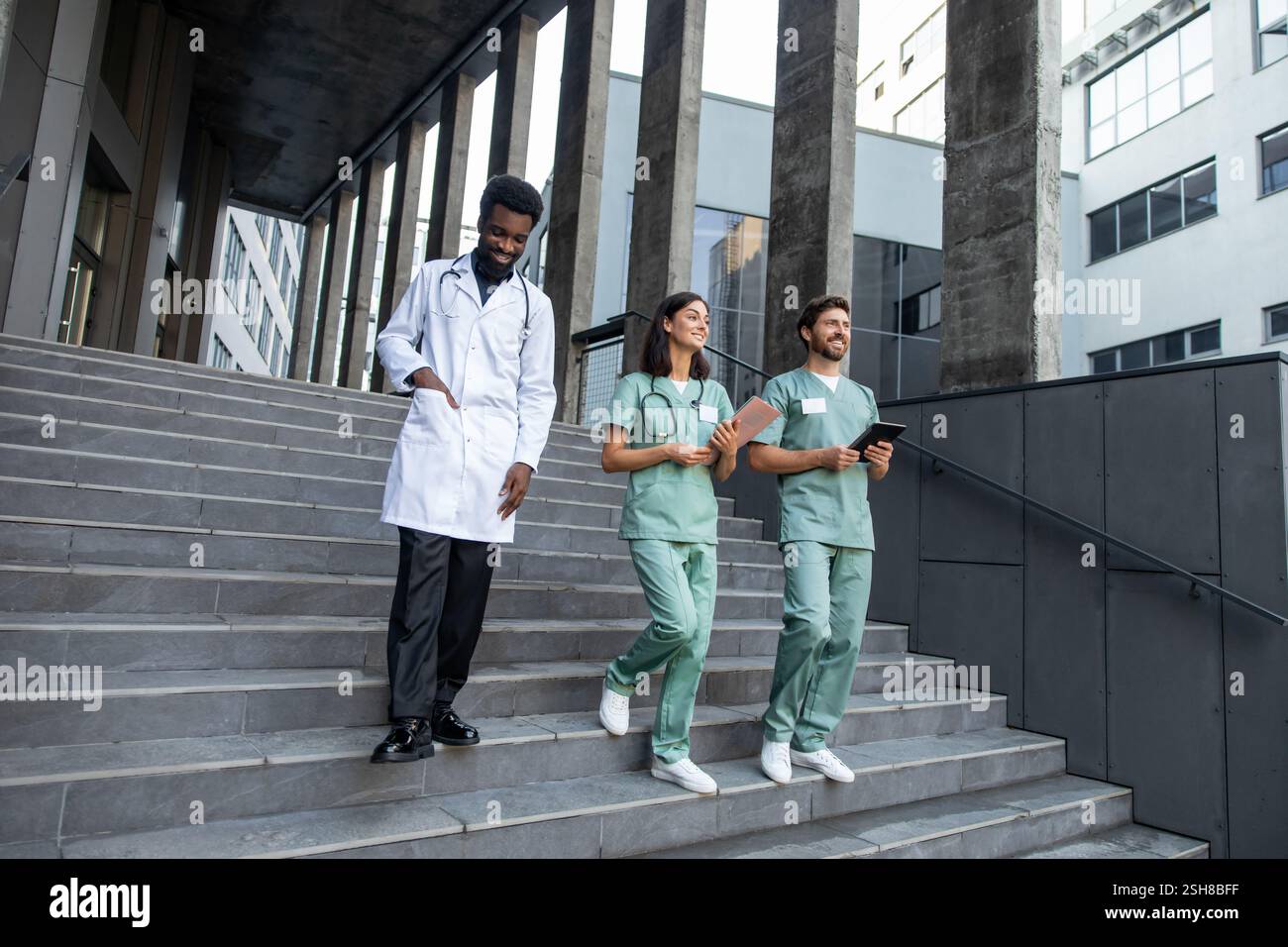 Doctors colleagues on the steps going from the rehabilitation center ...