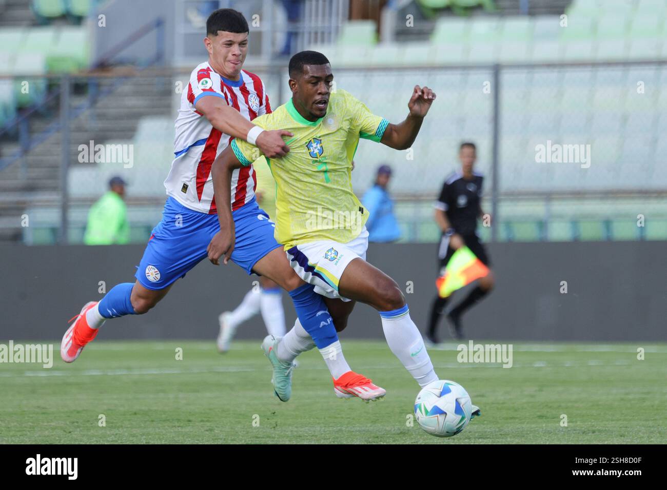 Brazil's Rayan, right, controls the ball chased by Paraguay's Axel ...