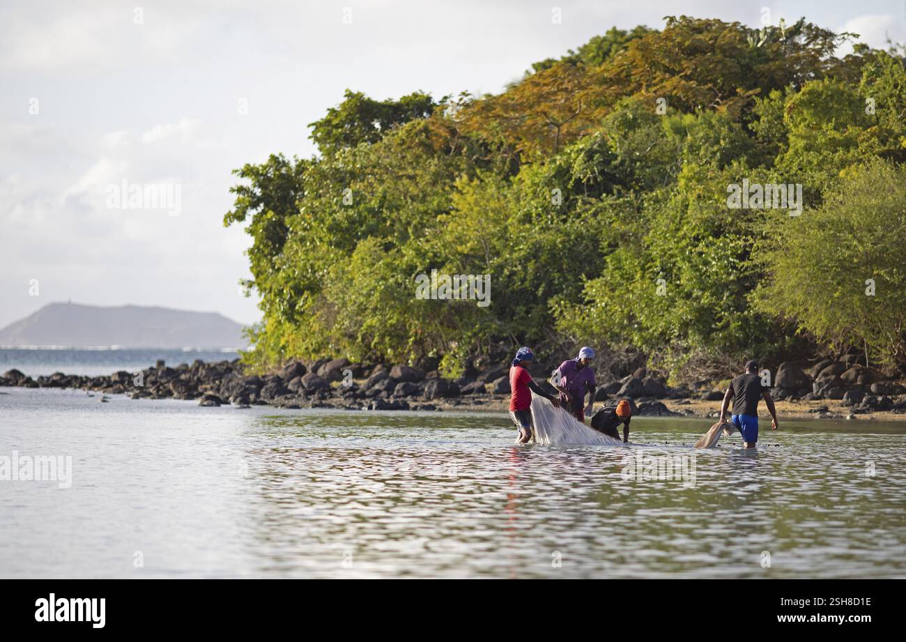Mauritian men fishing with a traditional net in the Indian Ocean near ...
