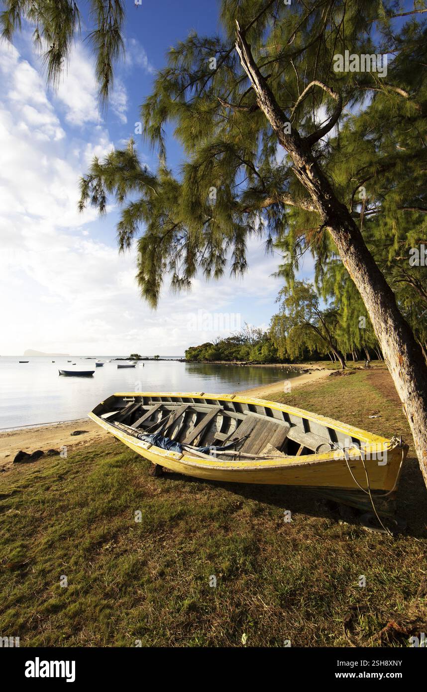 Yellow fishing boat on the beach at Calodyne, Riviere du Rempart ...