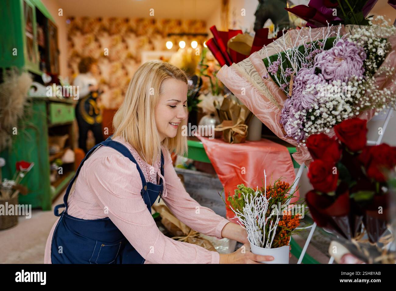 Flower arrangements come to life as a florist creates unique displays ...