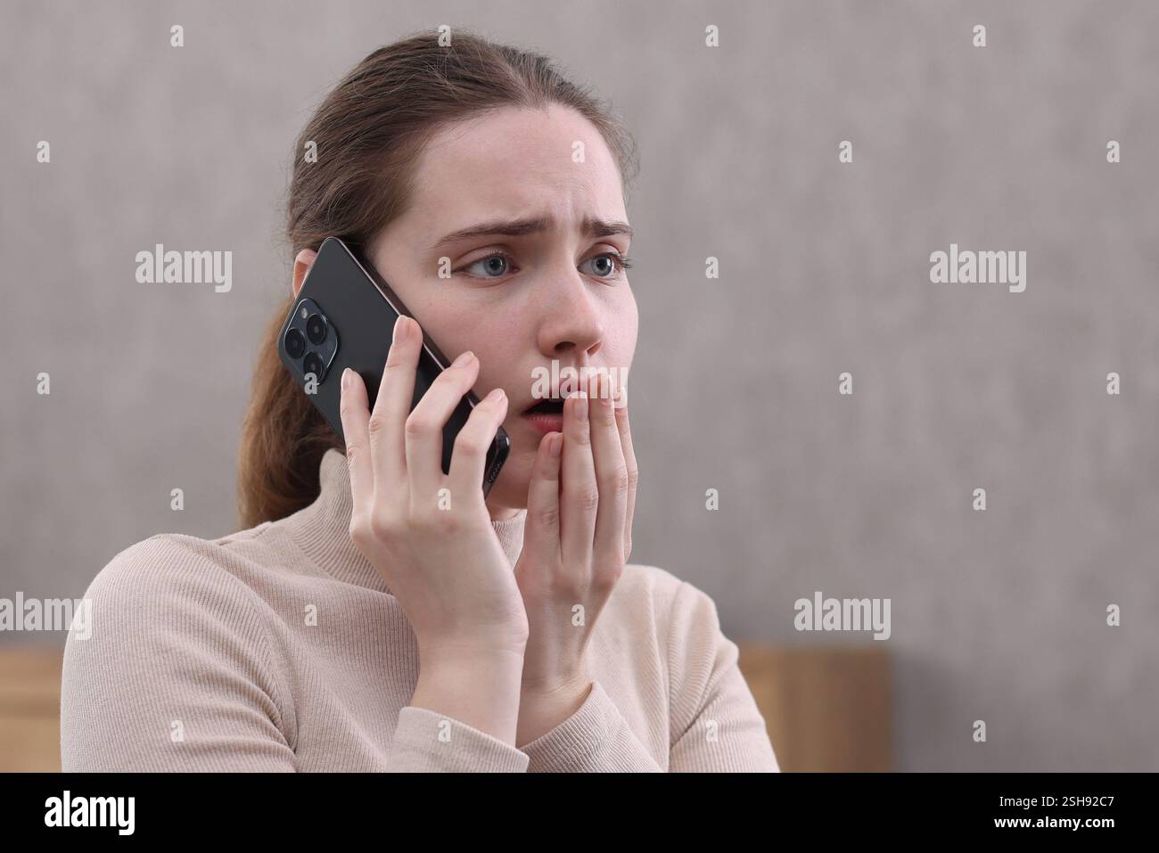 Stressed woman calling hotline for mental health help at home Stock ...