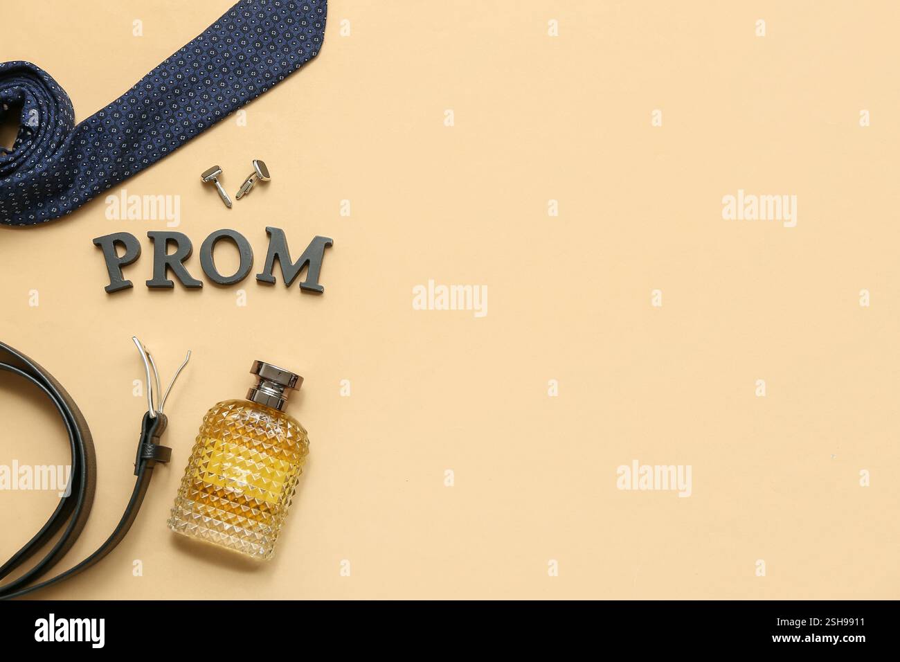 Word PROM with tie, belt and perfume bottle on beige background Stock ...