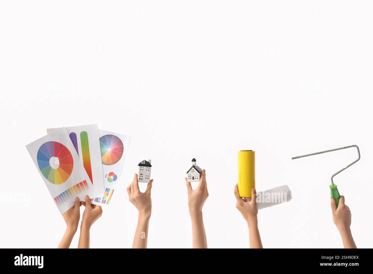 Architects with house figures, paint color palettes and roller on white ...