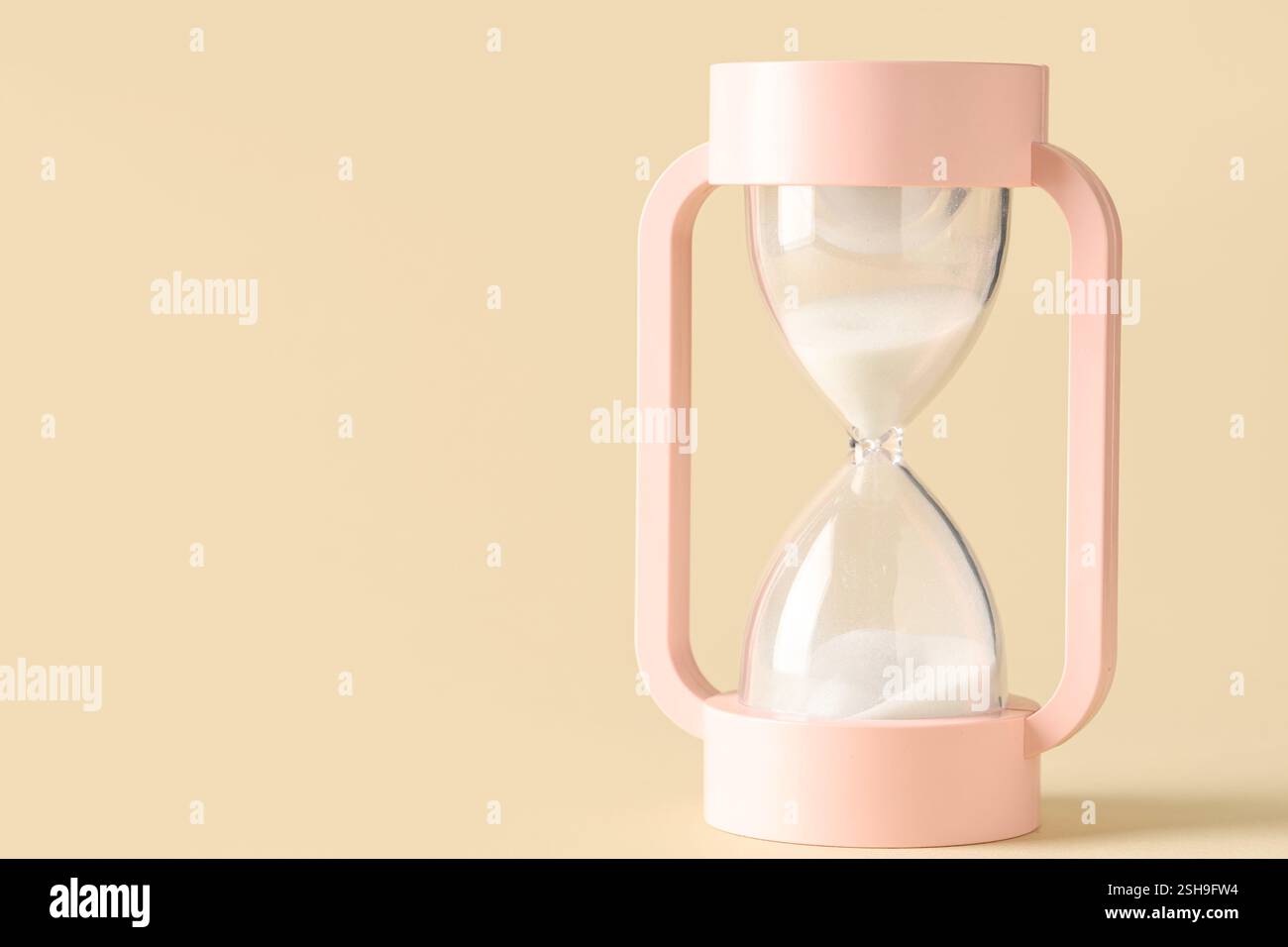 Hourglass on beige background. Time management concept Stock Photo - Alamy