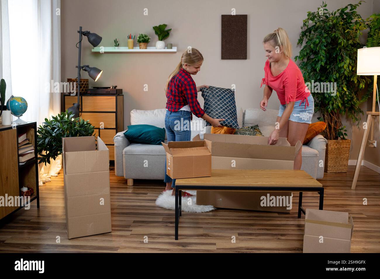 Home Organization Unpacking Boxes in a Bright and Inviting Living Room ...