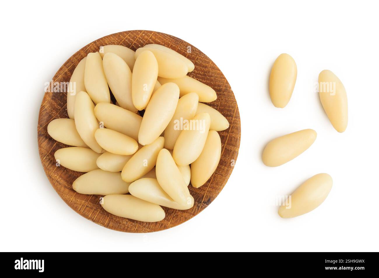 Shelled European pine nuts in wooden bowl isolated on white background ...