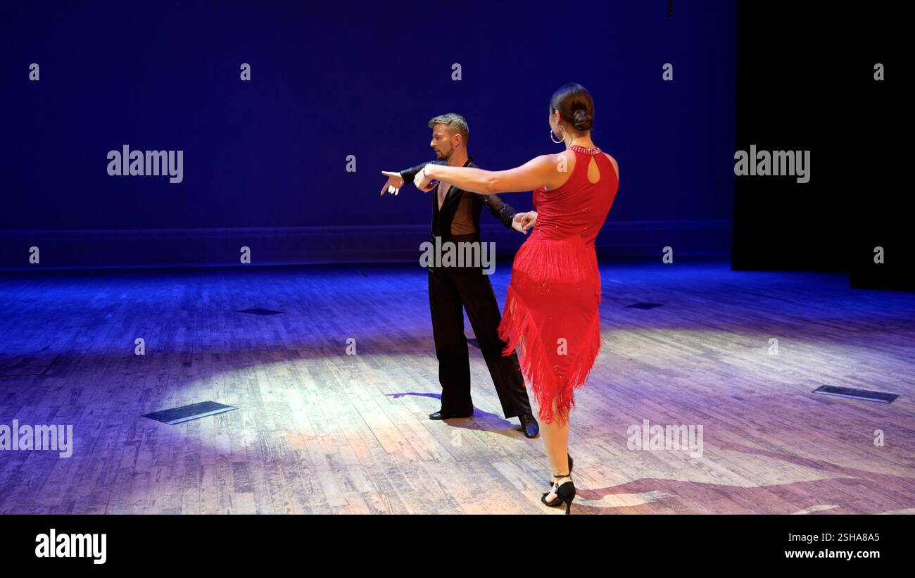 Ballroom couple dancing on stage. Feet closeup of Argentinian tango ...