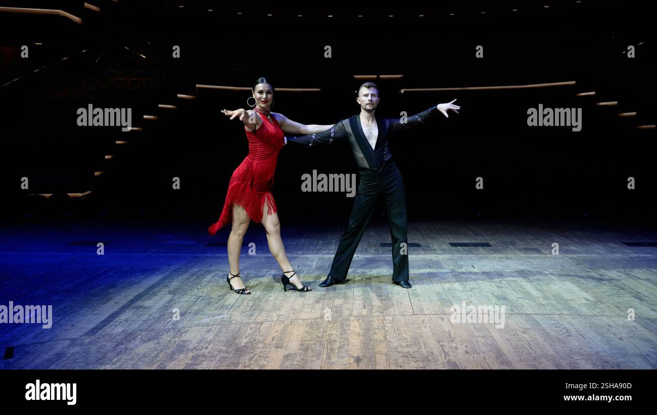 Professional dancers performing passionate rumba routine, showcasing ...