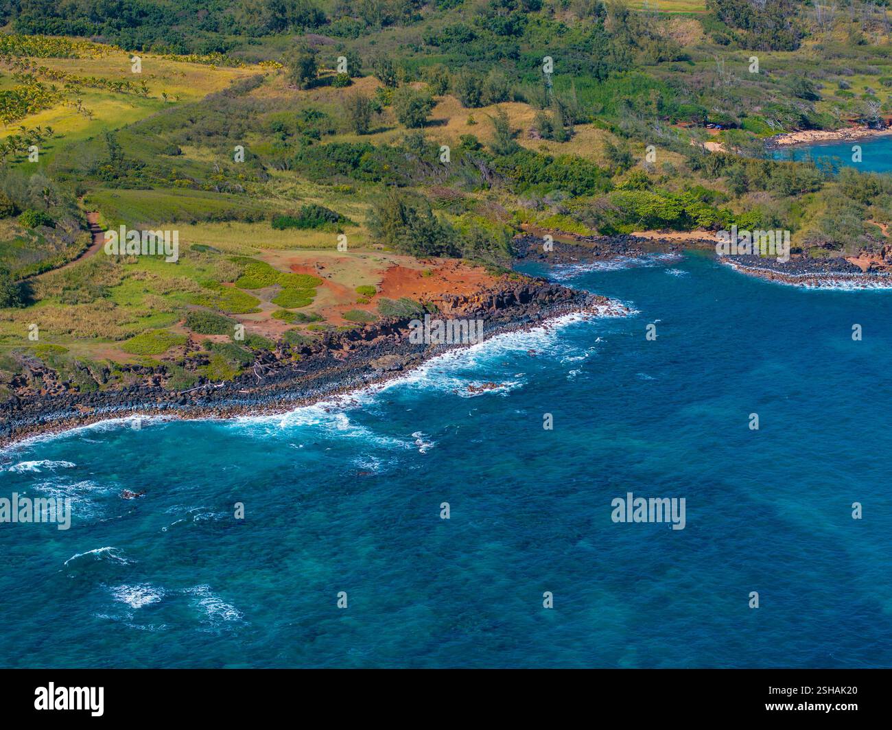 Aerial View of Kauai's Rugged Coastline with Volcanic Rocks and Waves ...