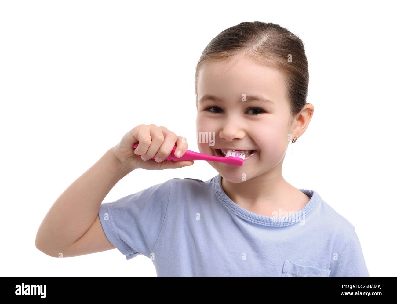 Cute girl brushing her teeth on white background Stock Photo - Alamy