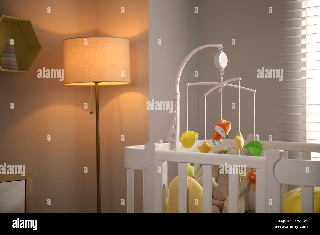 Crib with baby mobile in child's room Stock Photo - Alamy