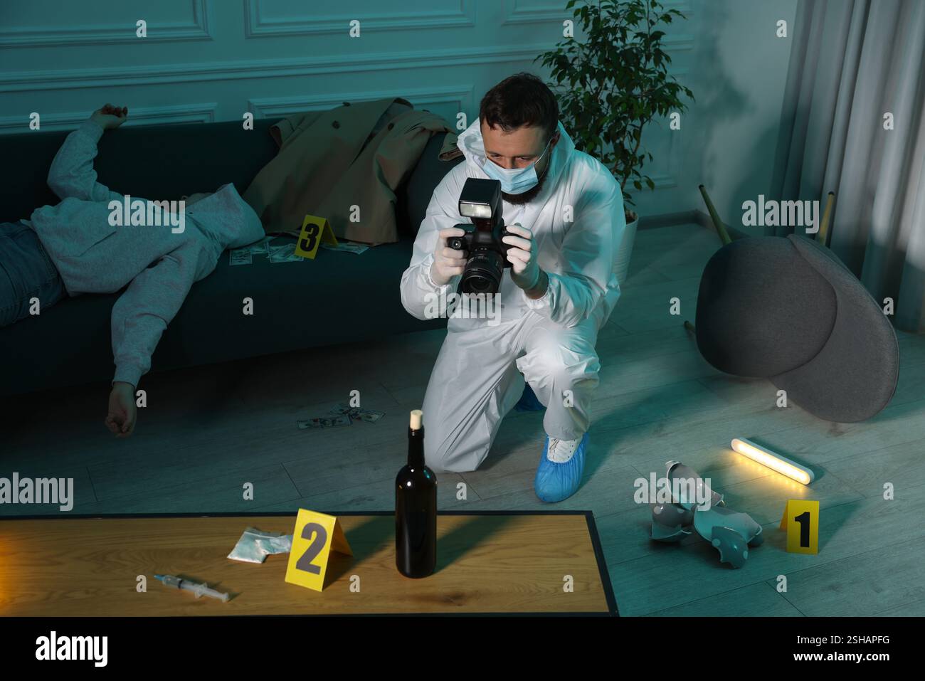 Forensic expert with camera working at crime scene and dead woman's ...