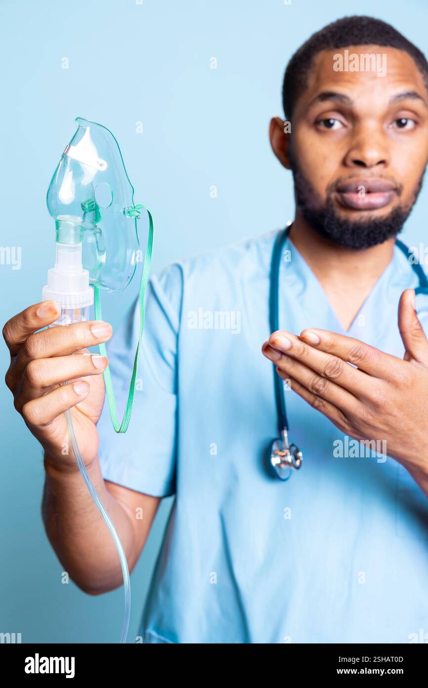 Medical assistant holding nebulizer used for aerosols therapy to help ...