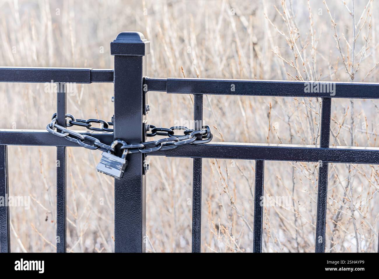 Fence sections secured with chain and lock Stock Photo - Alamy