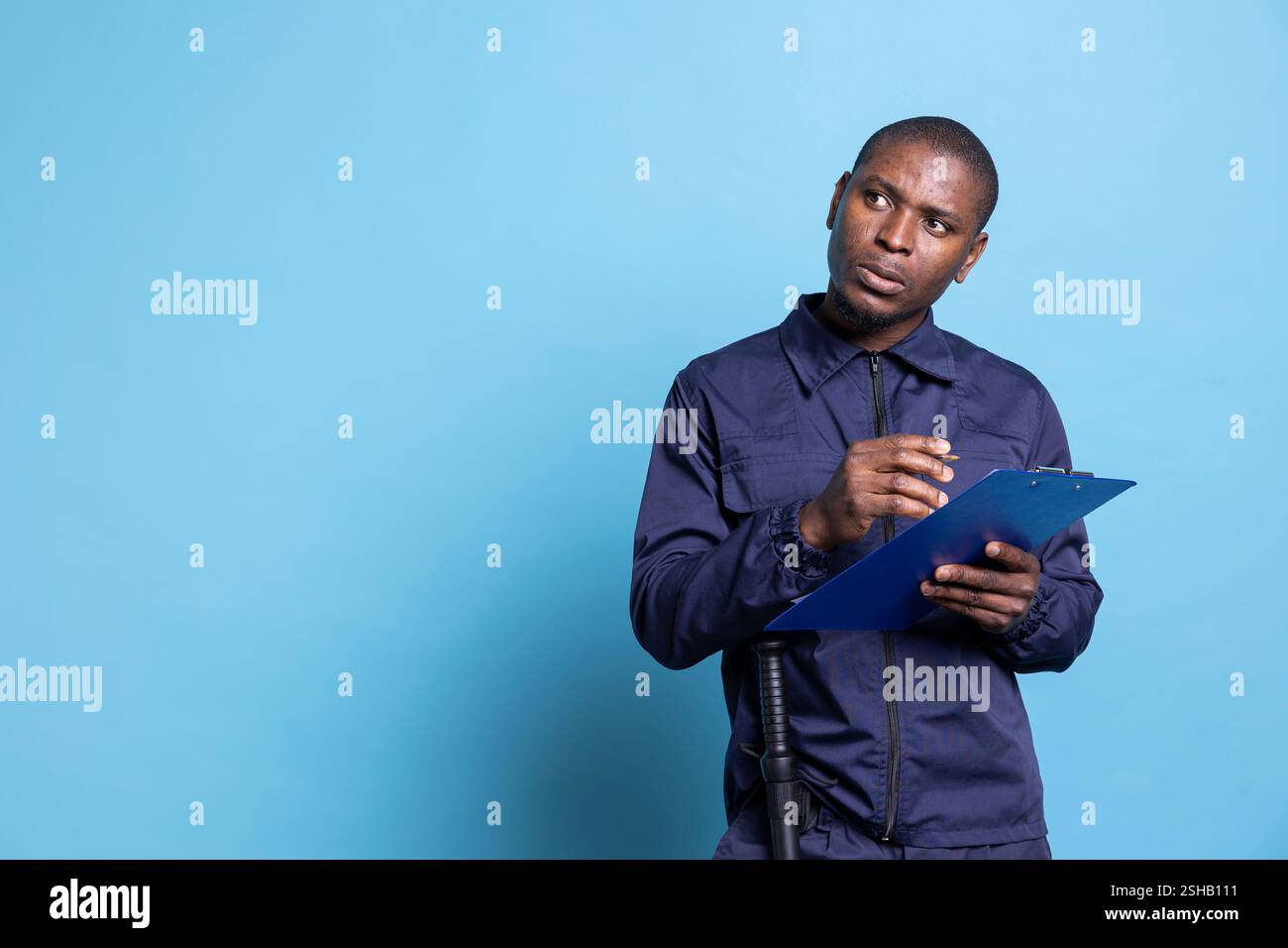 Security officer creating a list on clipboard files against blue ...