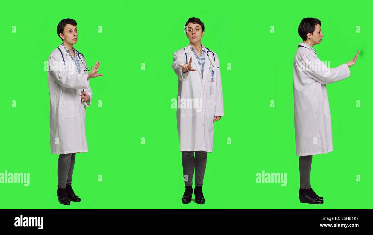 Woman health specialist showing no sign and being furious against greenscreen backdrop ...