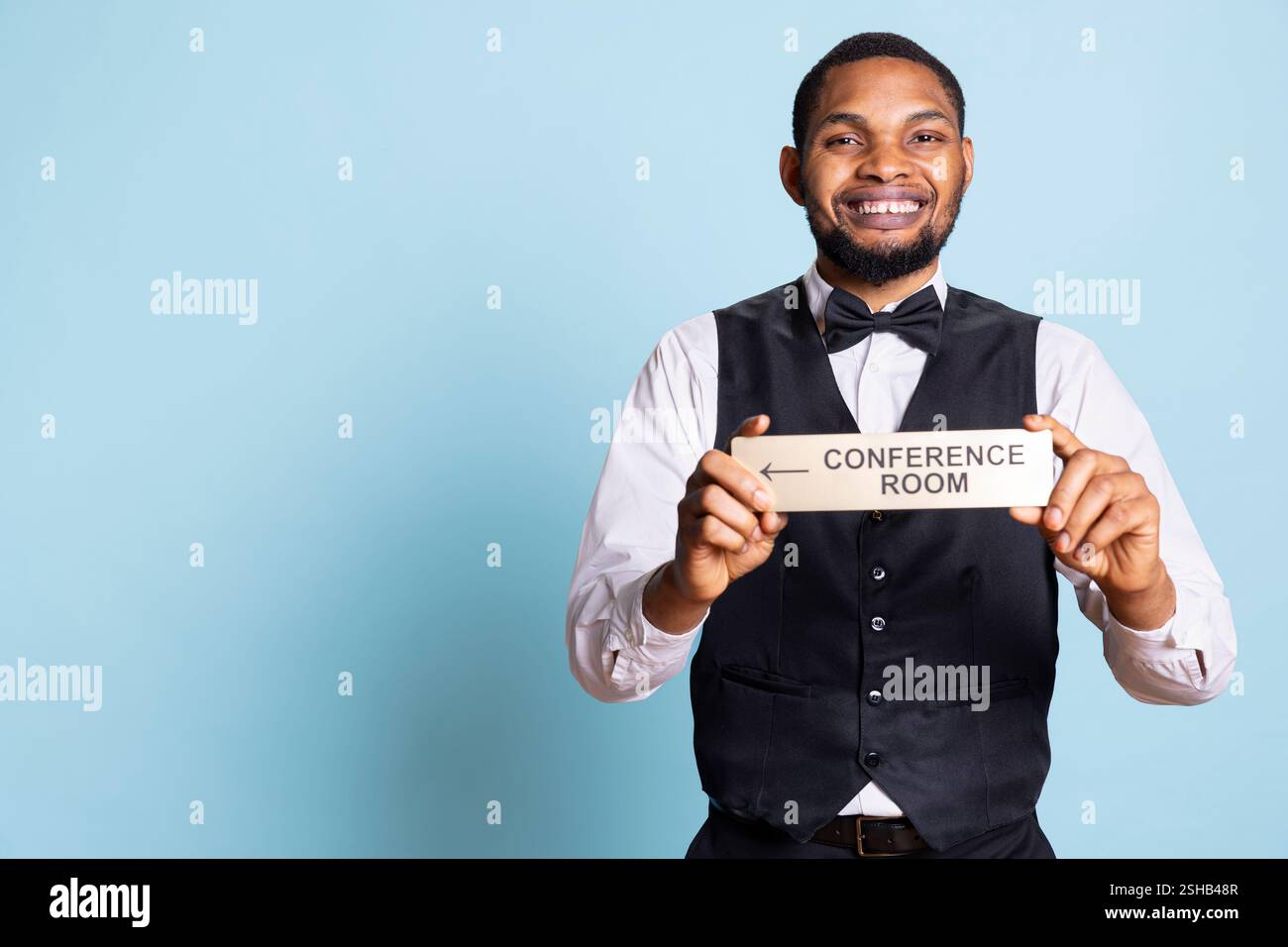 Hospitality industry staff showing the wall sign pointer to the ...