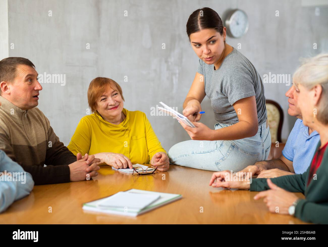 Young female professor giving lecture to elderly students Stock Photo ...
